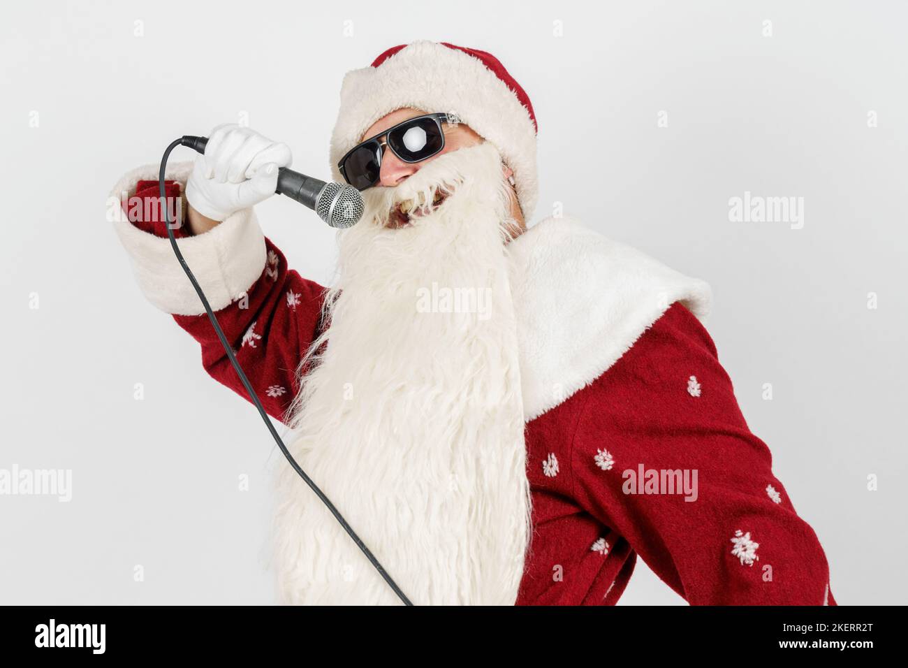 Holidays and christmas concept. Santa Claus sings with a microphone in ...