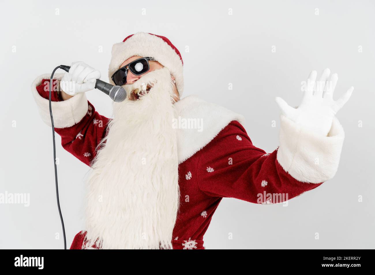 Holidays and christmas concept. Santa Claus sings with a microphone in ...