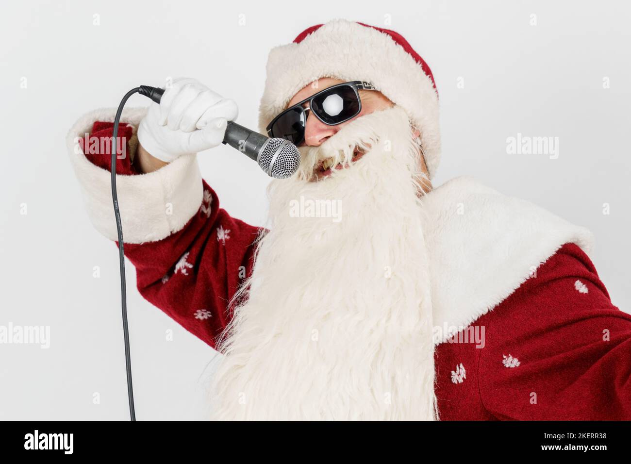 Holidays and christmas concept. Santa Claus sings with a microphone in ...