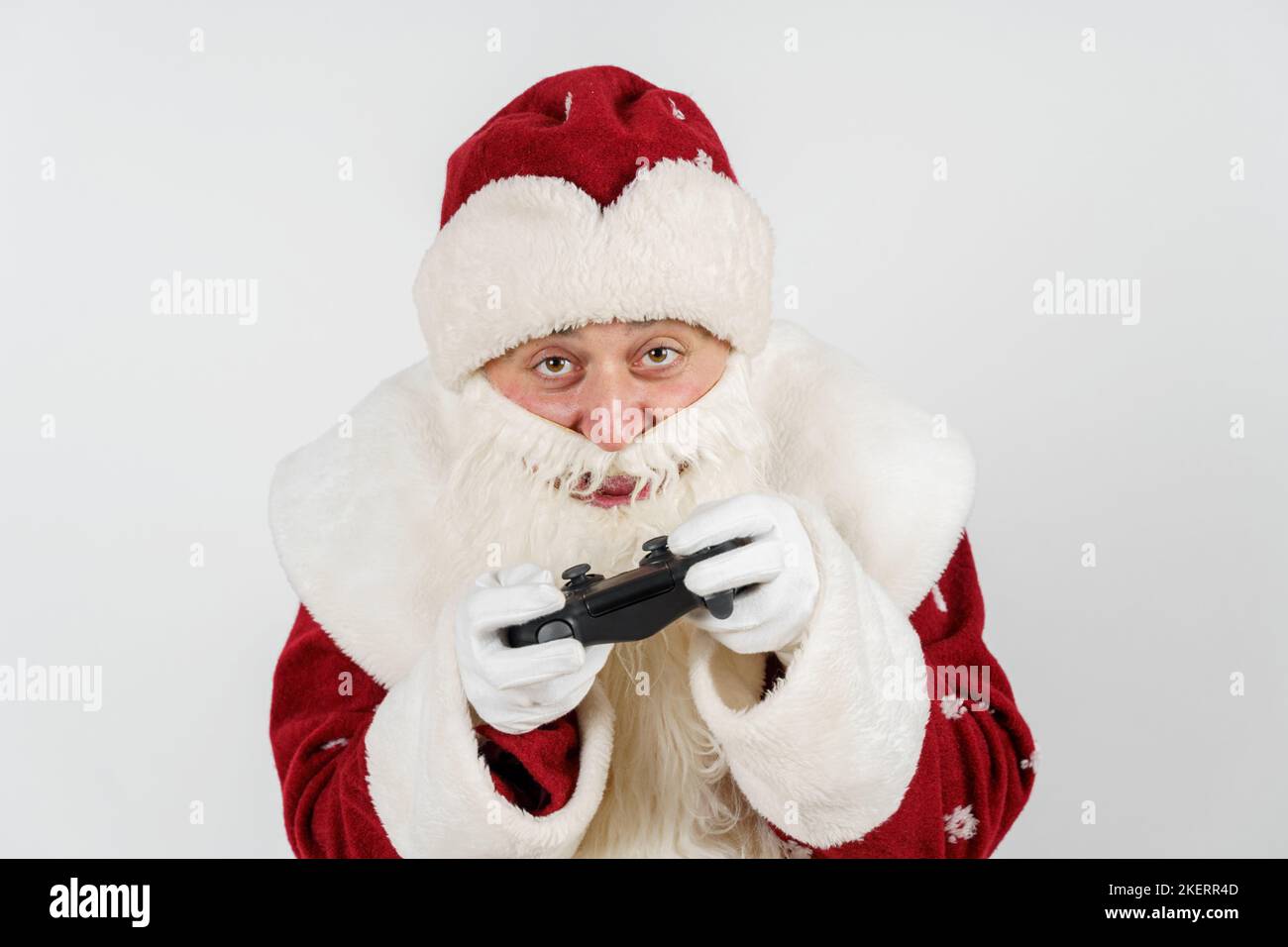 Holidays and Christmas concept. Santa Claus holds a joystick in his ...