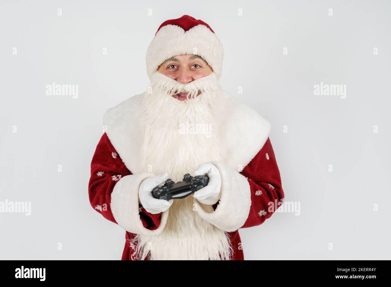 Holidays and Christmas concept. Santa Claus holds a joystick in his ...