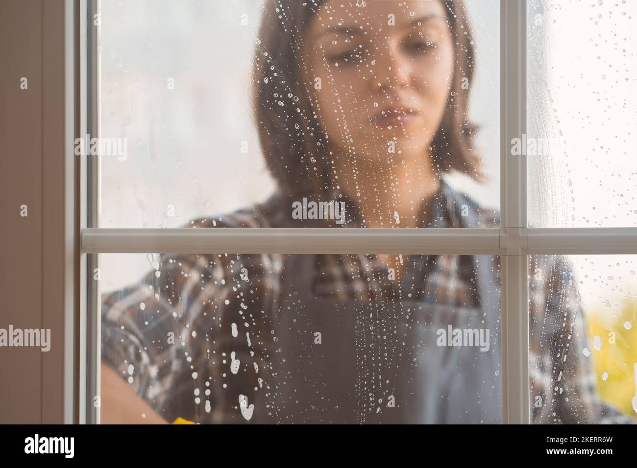 Woman washes the windows with a detergent Stock Photo - Alamy