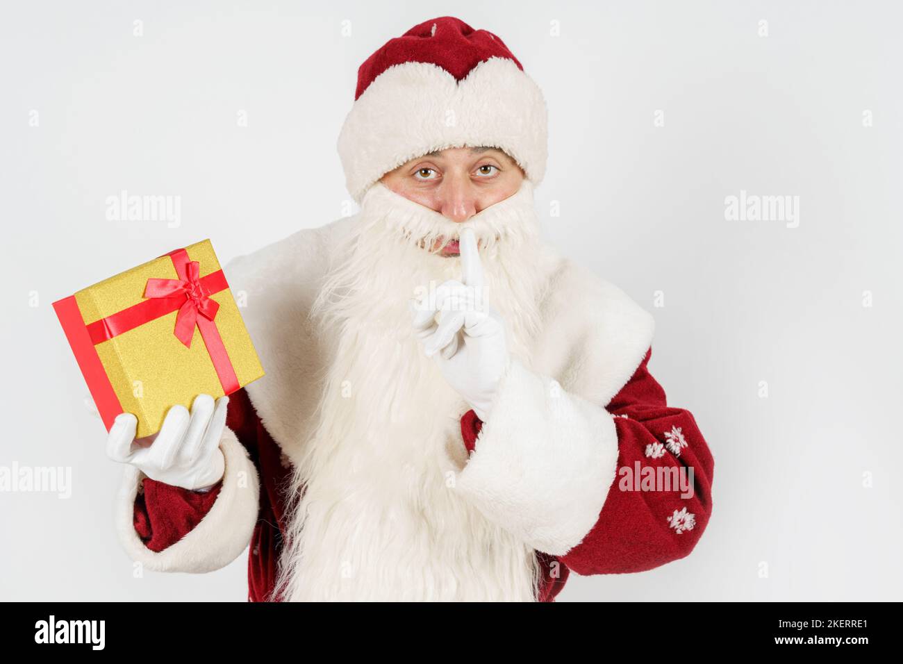 Holidays and Christmas concepts. Santa Claus holds a gift in his hand ...