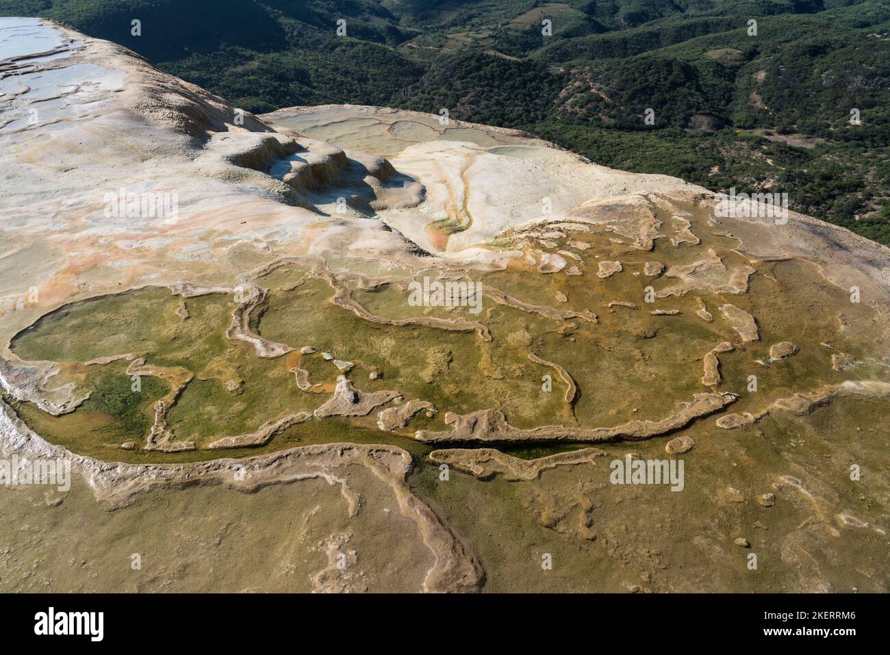 Travertine formations and a mineral pool above the Big Waterfall ...