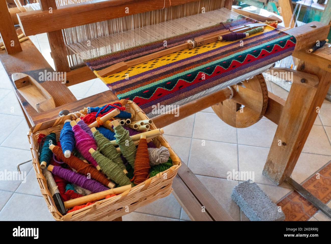 Woolen rugs made with natural dyes being woven on wooden foot-treadle ...
