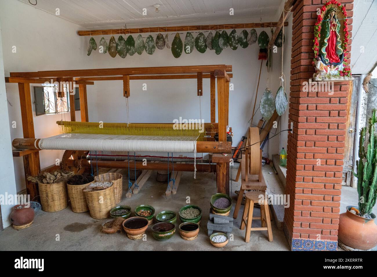 A wooden foot treadle loom for making woolen rugs in the weaving center ...