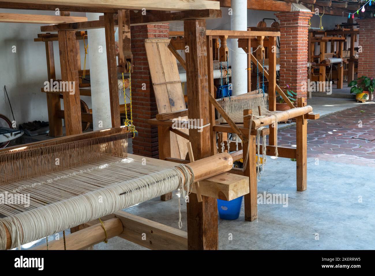 Wooden foot-treadle looms for making woolen rugs in a home workshop in ...