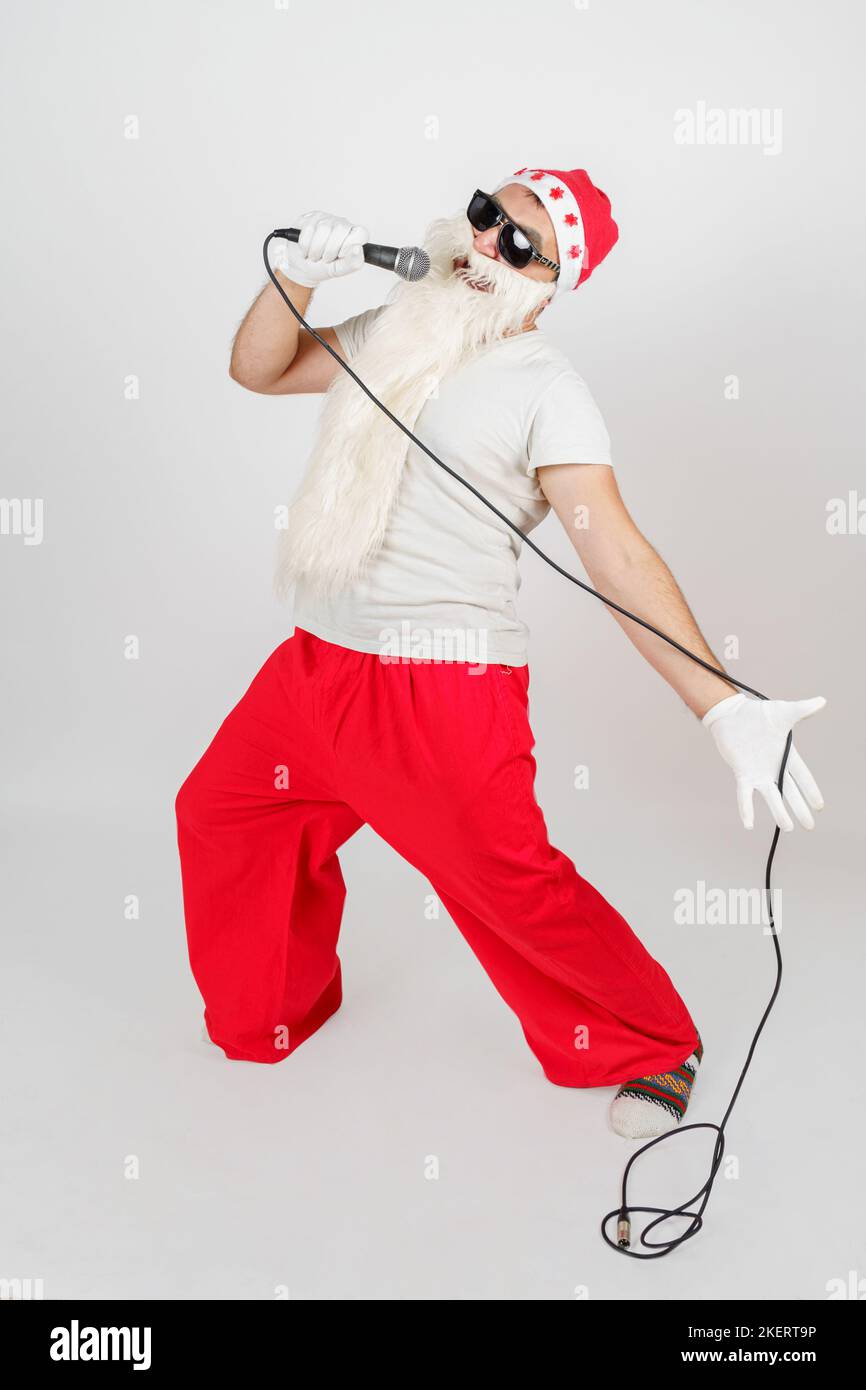 Holidays and christmas concept. Santa Claus sings with a microphone in ...