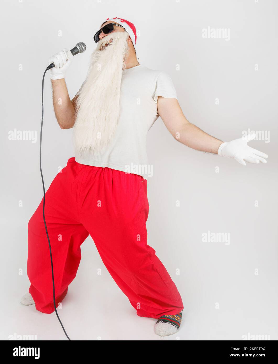 Holidays and christmas concept. Santa Claus sings with a microphone in ...