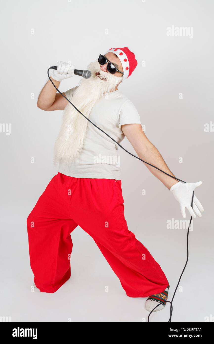 Holidays and christmas concept. Santa Claus sings with a microphone in ...