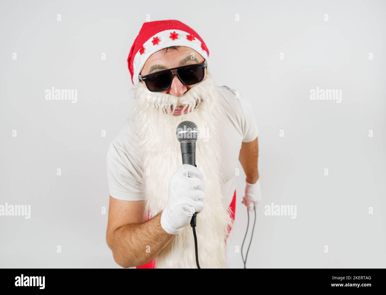Holidays and christmas concept. Santa Claus sings with a microphone in ...
