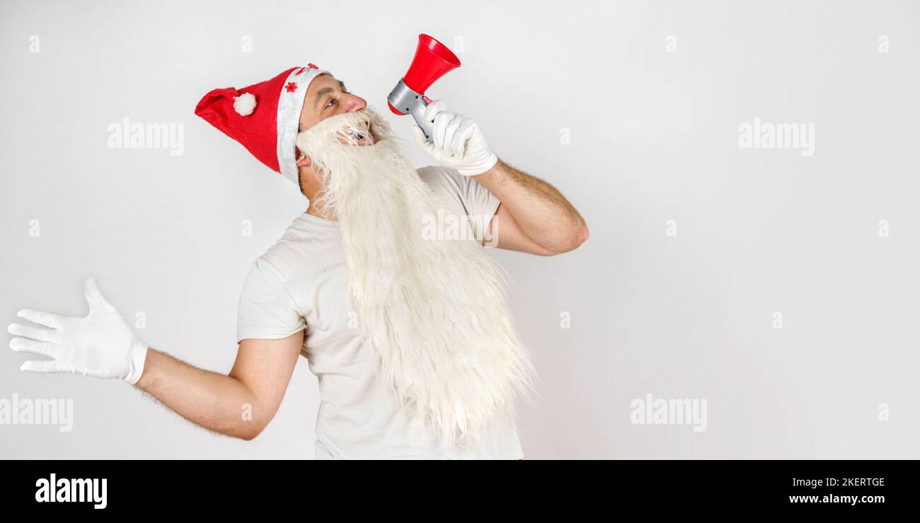 Christmas and New Years concept. Santa Claus announces in a megaphone ...