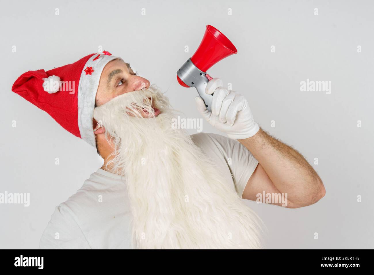 Christmas and New Years concept. Santa Claus announces in a megaphone ...