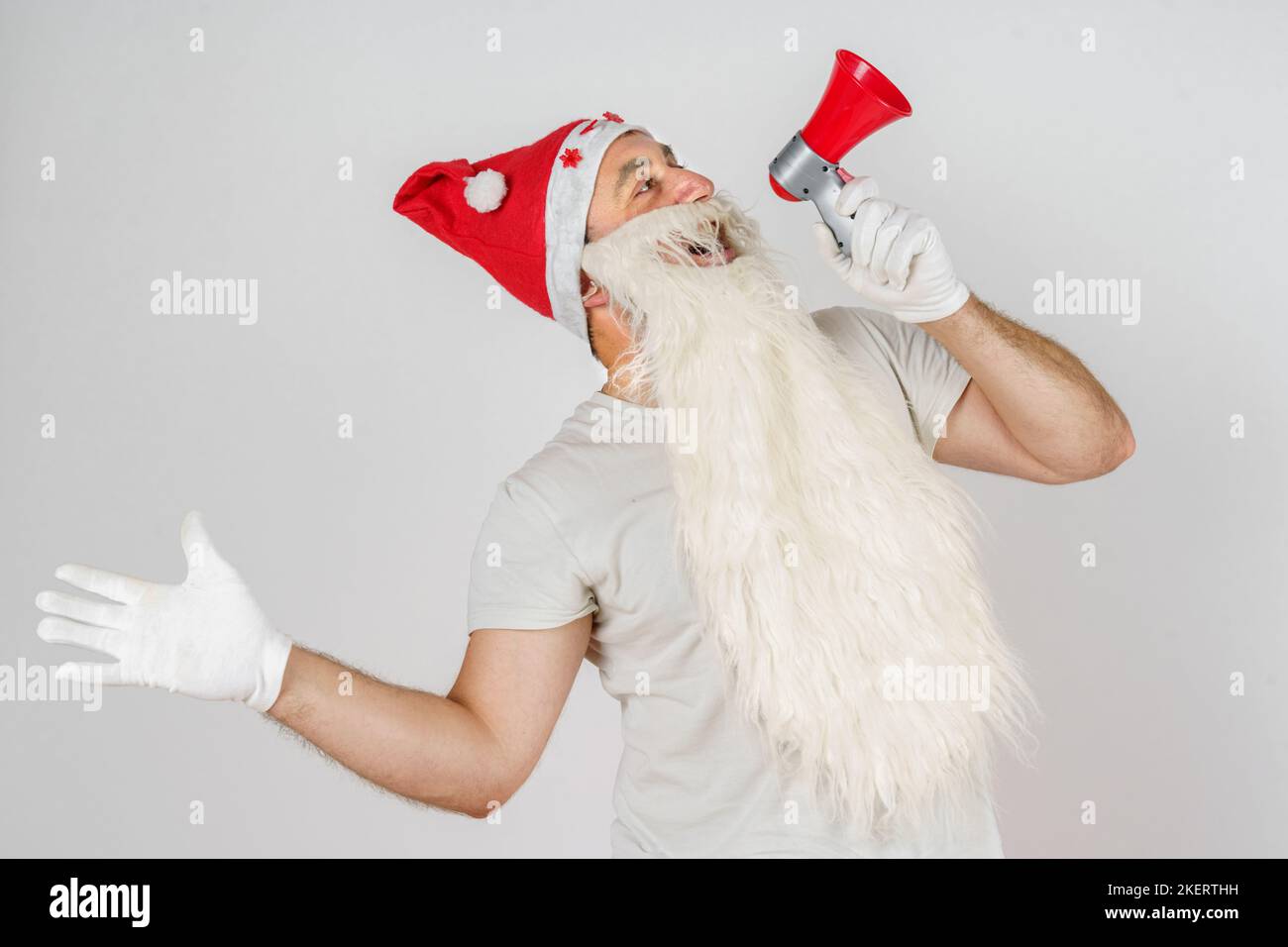 Christmas and New Years concept. Santa Claus announces in a megaphone ...