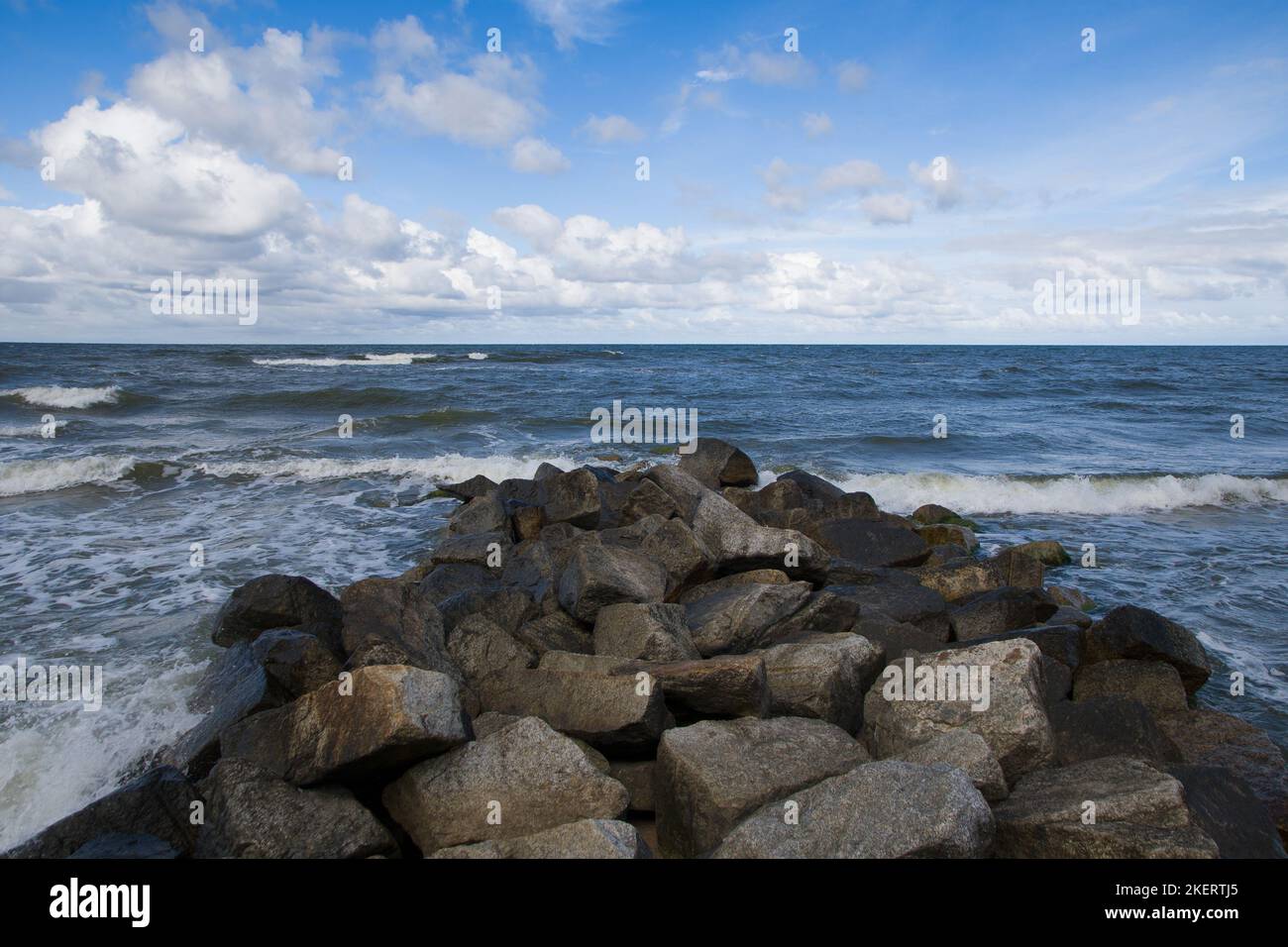 Wave hit the rock at beach, sea water splash up to the sky with ...