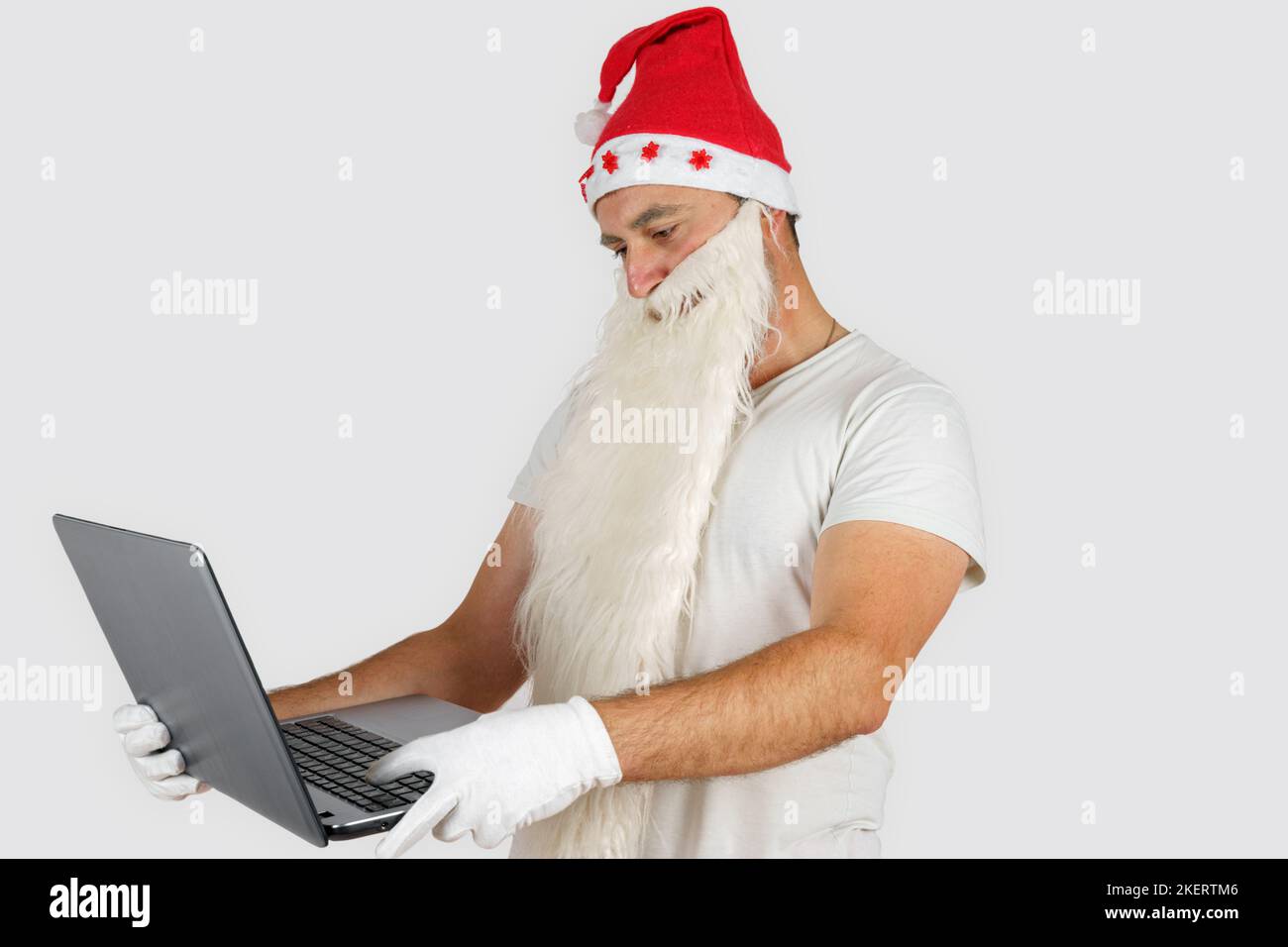 Christmas and New Year concept. Santa Claus sits at his desk and works ...