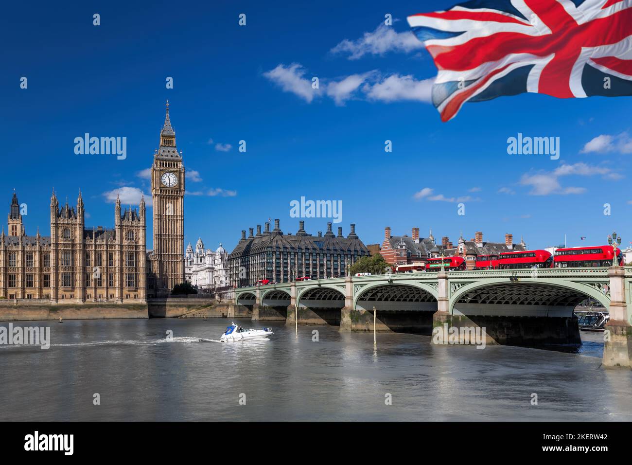 Big Ben with red buses on bridge over Thames river with boat in London ...