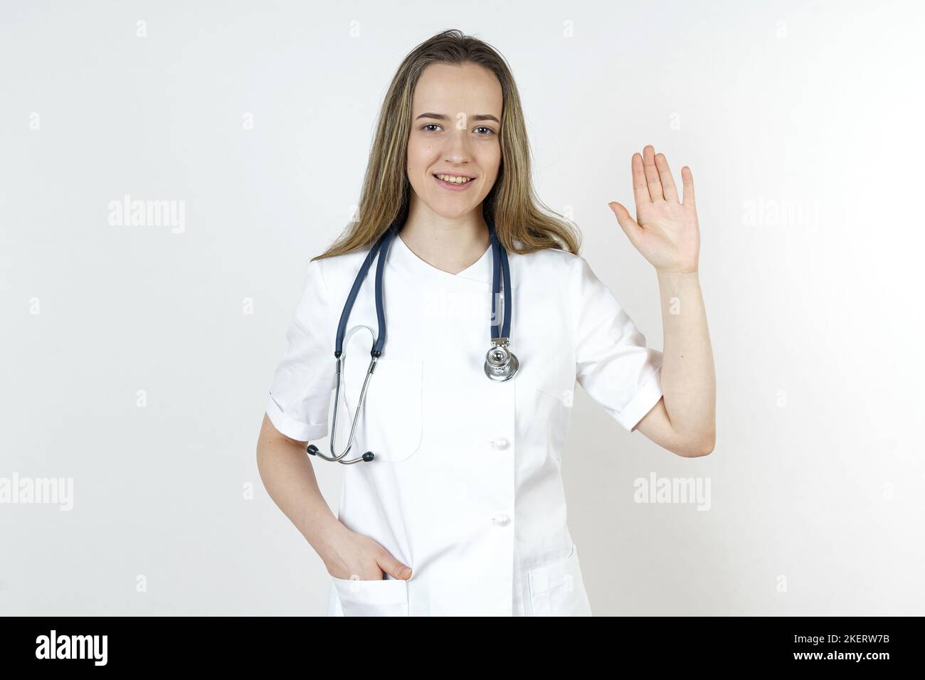 Medicine and health concept. Doctor woman greets by raising her hand up ...