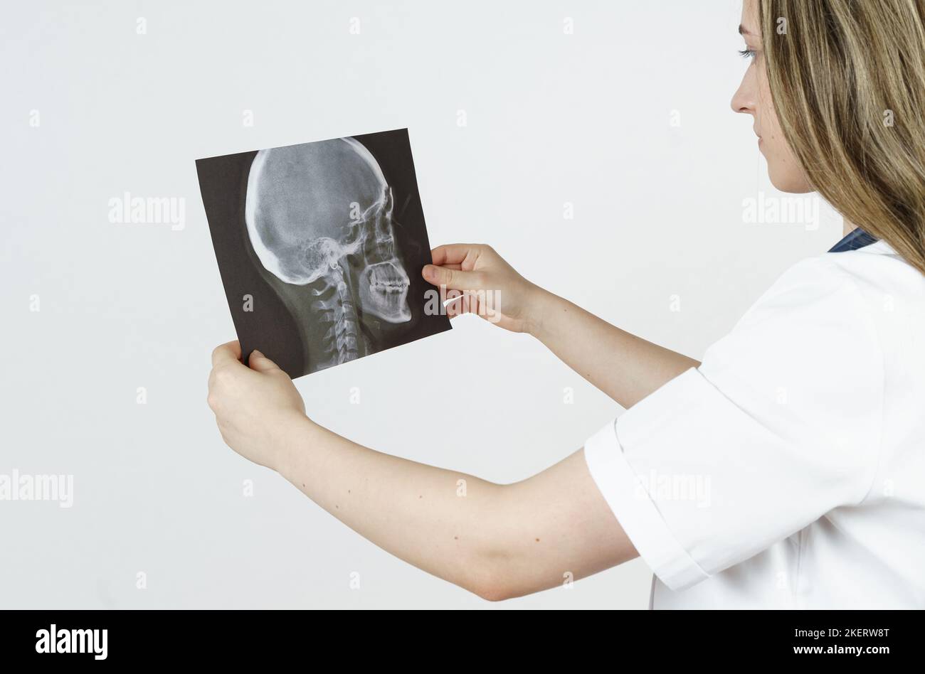 Medicine and health concept. Young woman doctor examines an x-ray of ...
