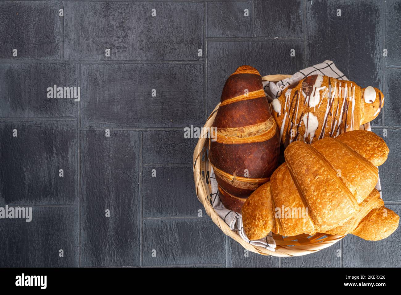Freshly baked croissants with coffee espresso cup on black tiled ...