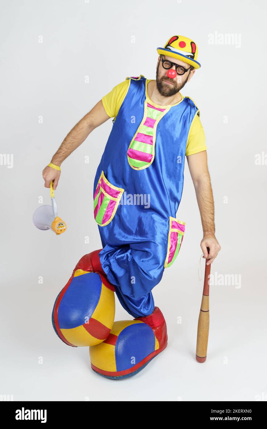 Holiday concept. The clown is a man in a bright blue and yellow suit ...