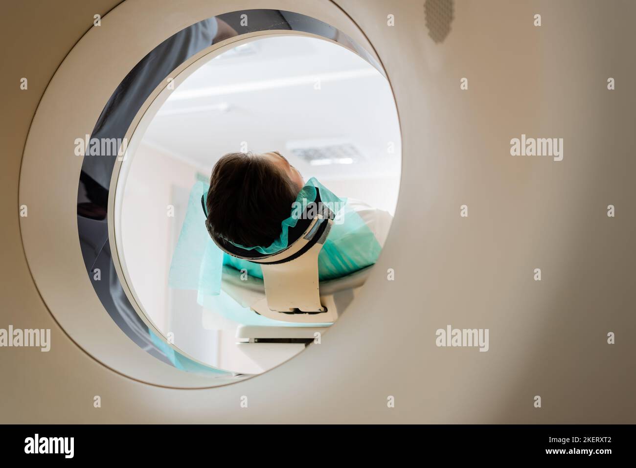 brunette man during procedure of scanning in computed tomography ...