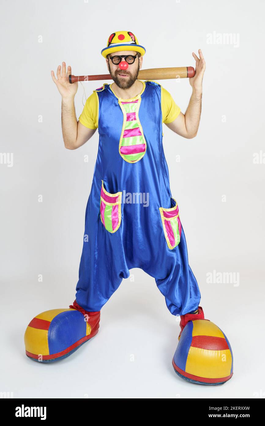 Holiday concept. The clown is a man in a bright blue and yellow suit ...