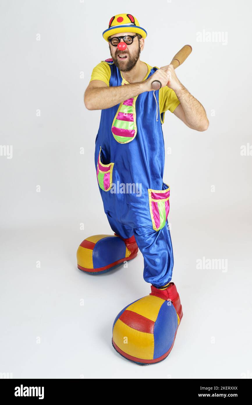 Holiday concept. The clown is a man in a bright blue and yellow suit ...
