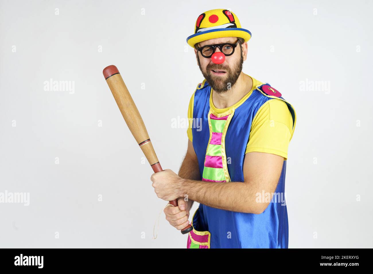 Holiday concept. The clown is a man in a bright blue and yellow suit ...