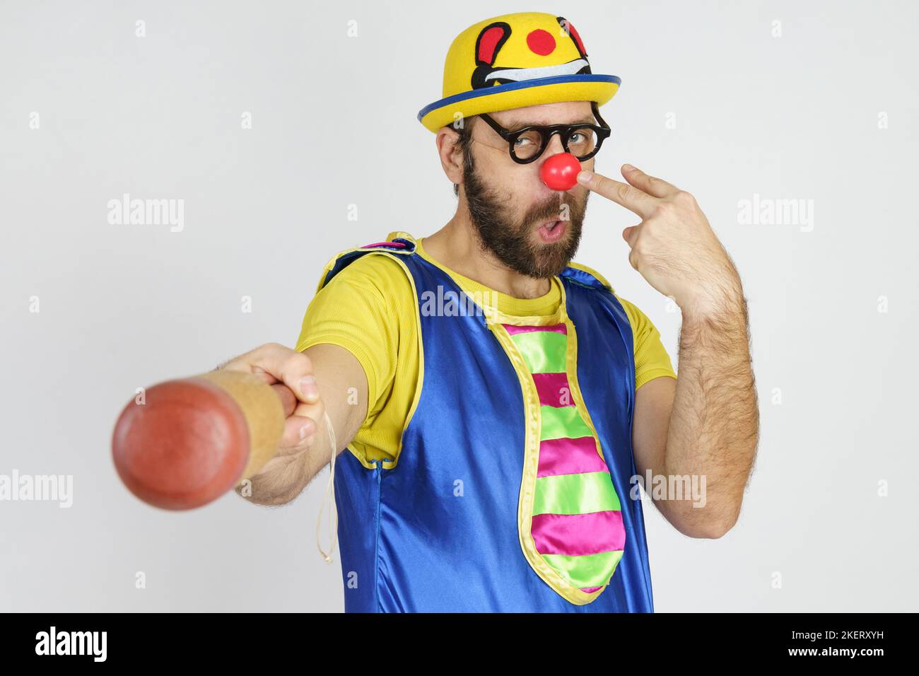 Holiday concept. The clown is a man in a bright blue and yellow suit ...