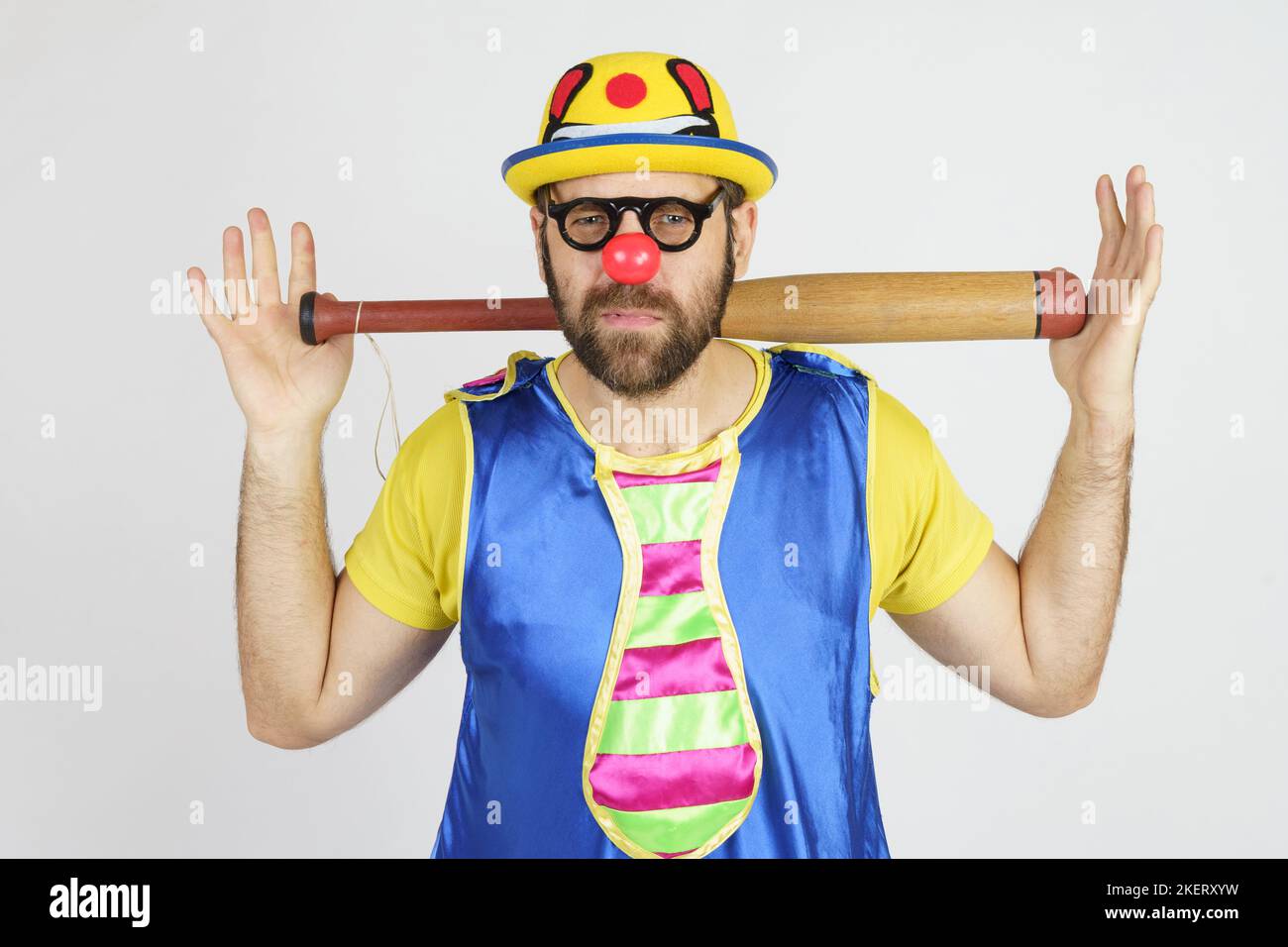 Holiday concept. The clown is a man in a bright blue and yellow suit ...
