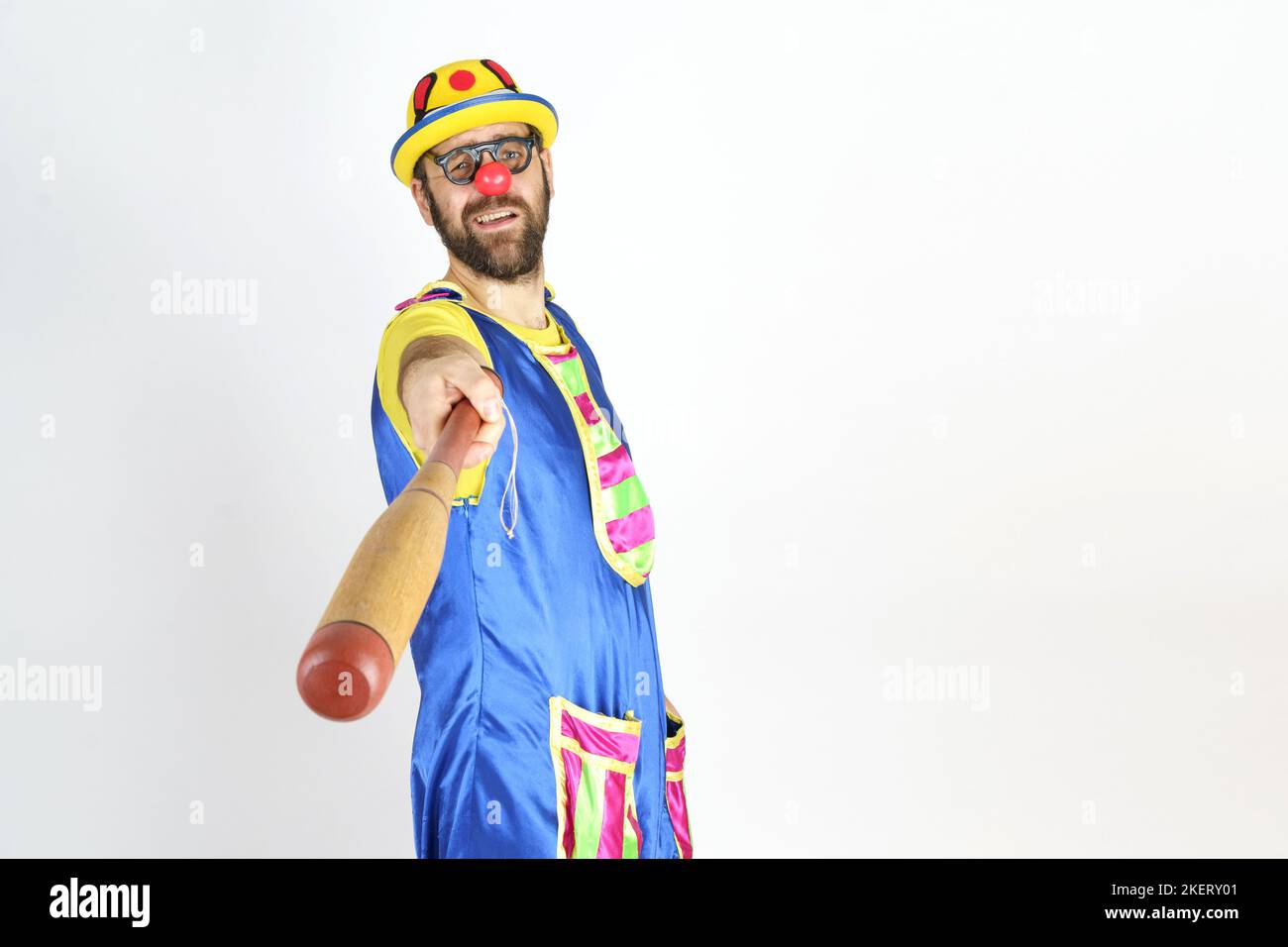 Holiday concept. The clown is a man in a bright blue and yellow suit ...