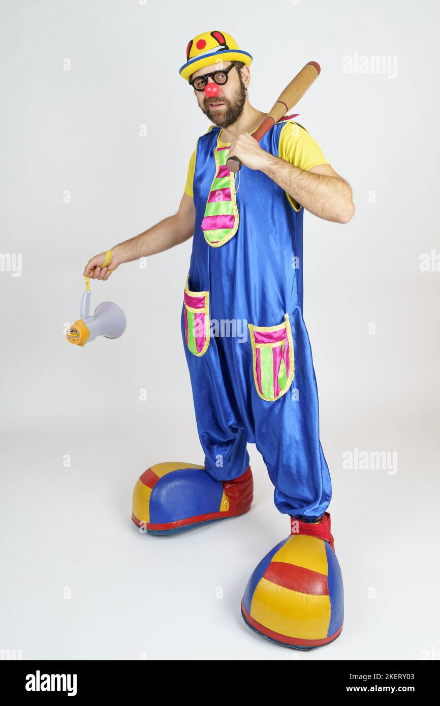 Holiday concept. The clown is a man in a bright blue and yellow suit ...
