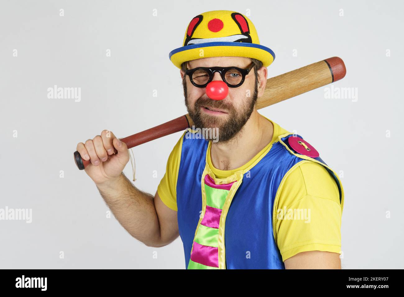 Holiday concept. The clown is a man in a bright blue and yellow suit ...