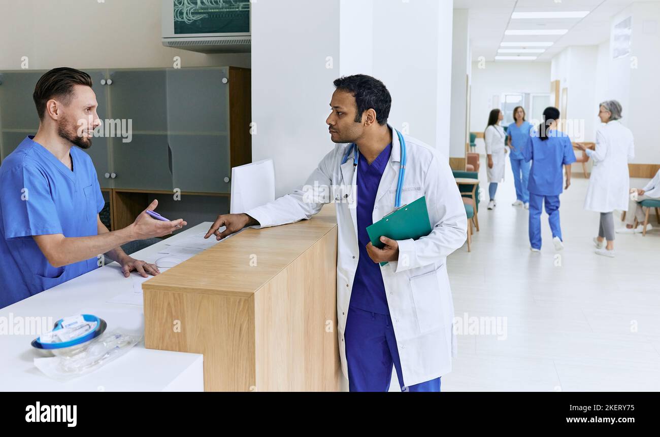 medical assistant on duty talking with Indian doctor while working day ...