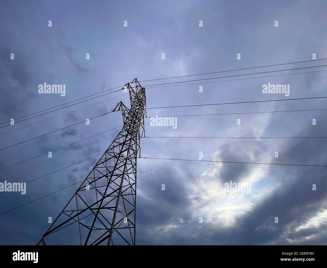 High voltage cable tower with cloudy sky at sunset Stock Photo - Alamy