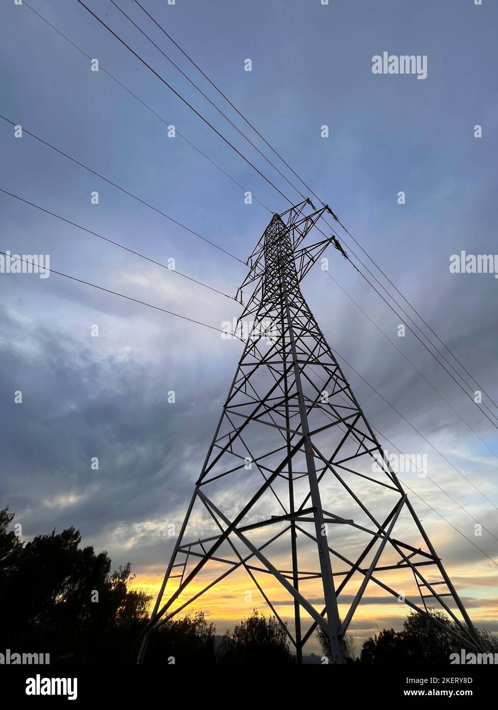 High voltage cable tower with cloudy sky at sunset Stock Photo - Alamy
