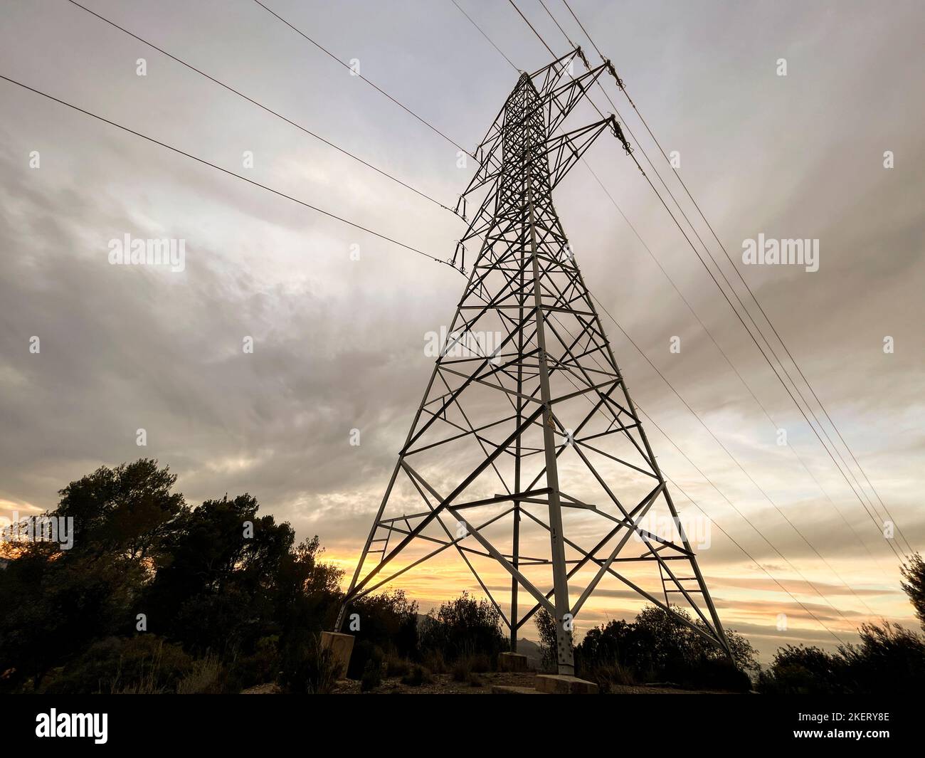 High voltage cable tower with cloudy sky at sunset Stock Photo - Alamy