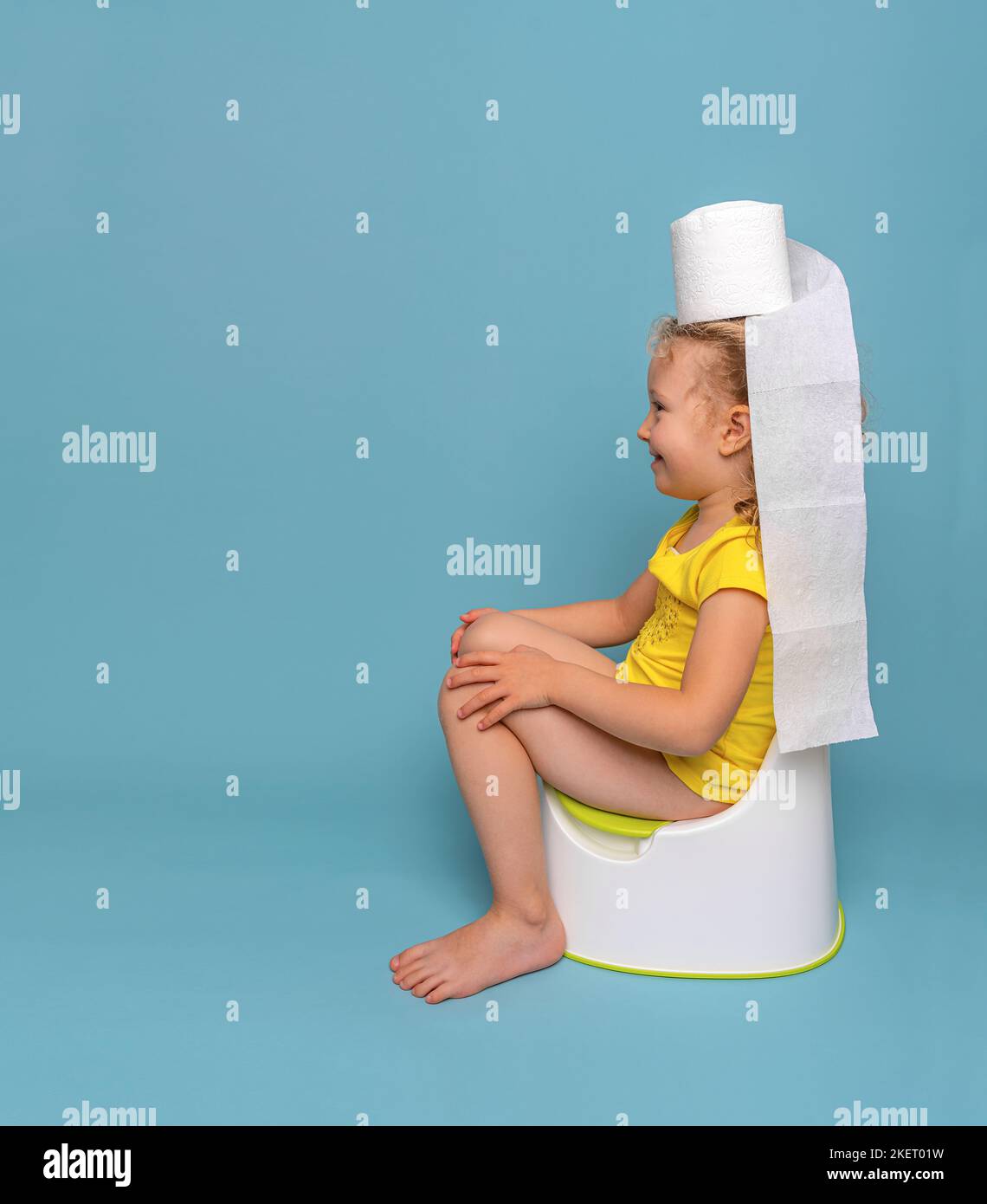A Child On The Potty Plays With Toilet Paper Stock Photo Alamy