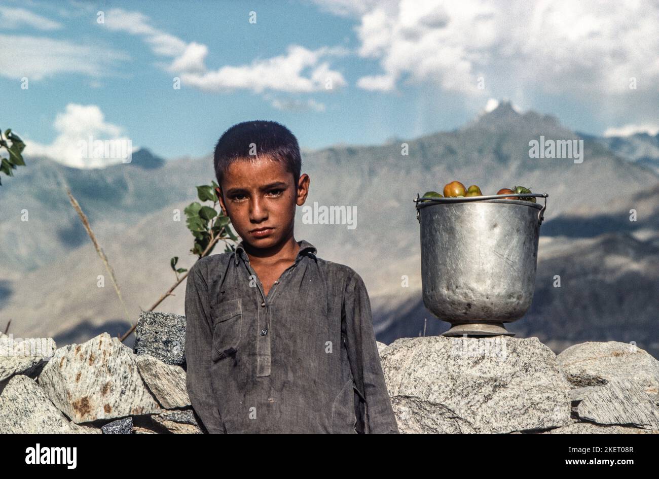 GILGIT, PAKISTAN - JUNE 30, 1986: local farmer boy takes home the ...