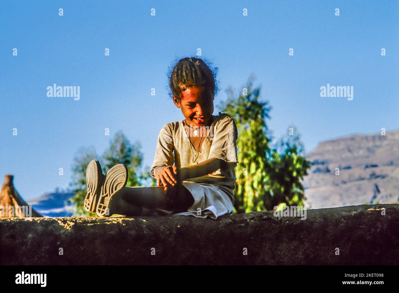 LALIBELA, ETHOPIA - JULY 1, 1998: young girl mith plastic boots sitting ...