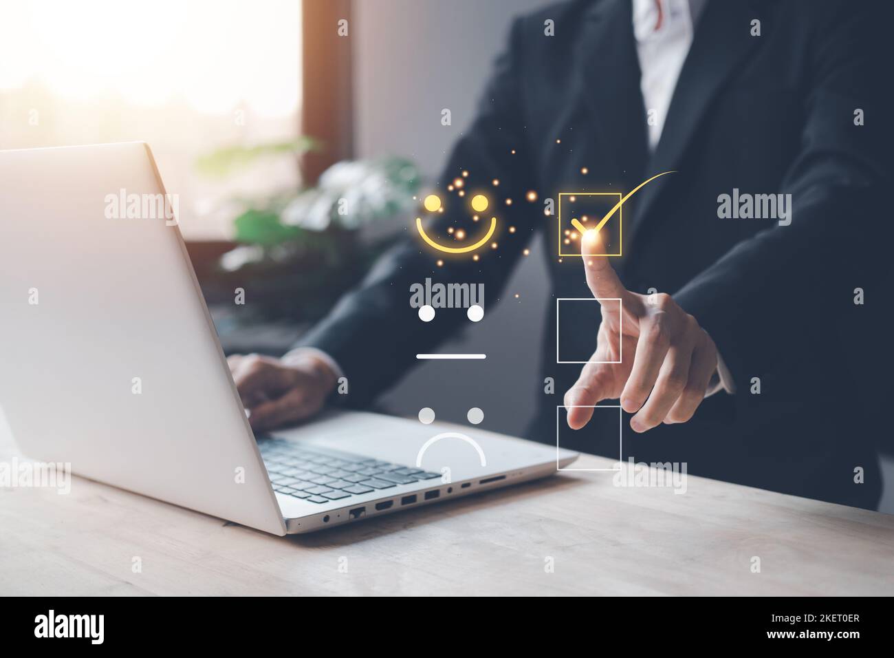 Reviews smile rating with businessman hand touch and typing notebook (Laptop). Customer service ...