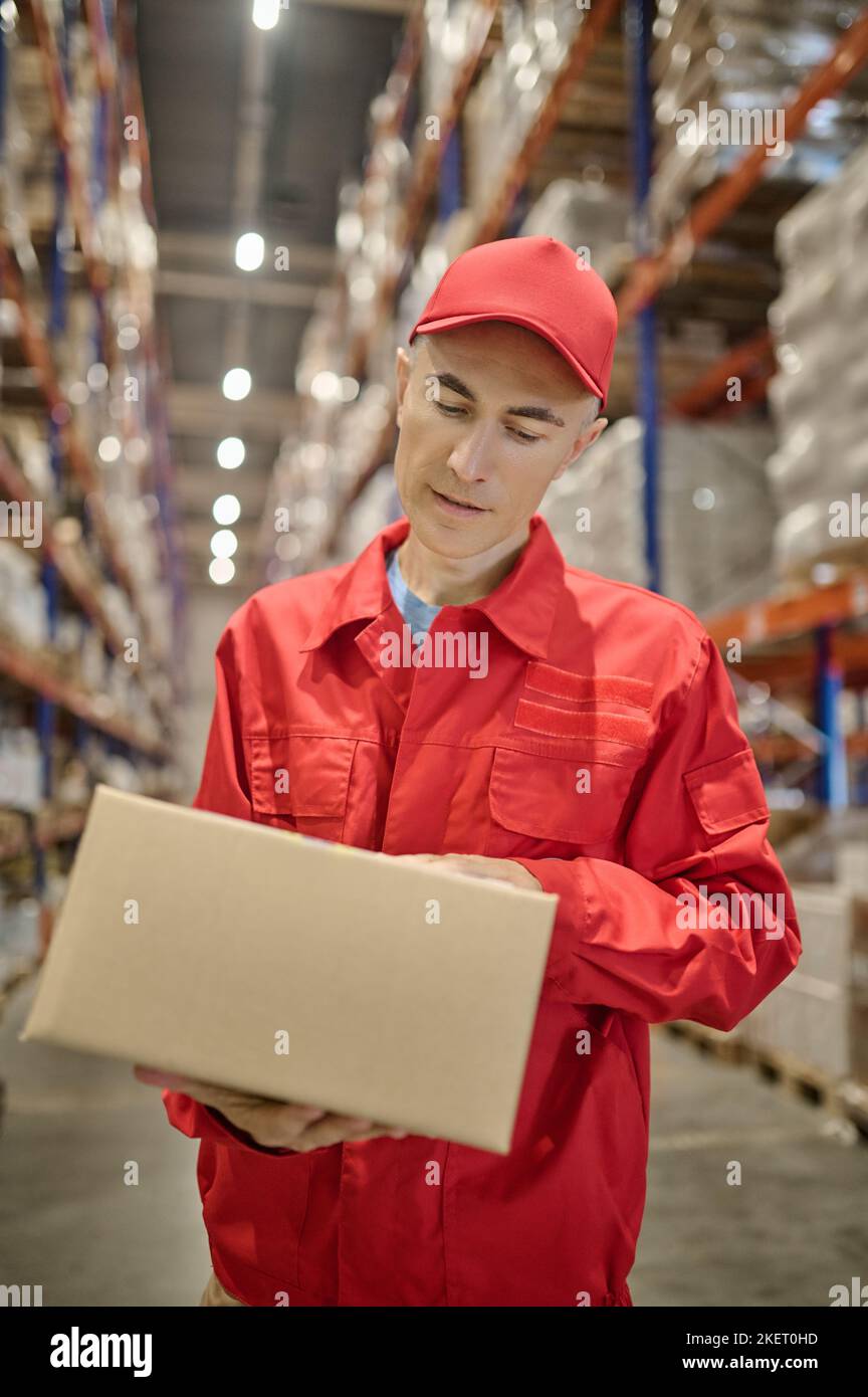 Warehouse loader working in the storage area Stock Photo - Alamy