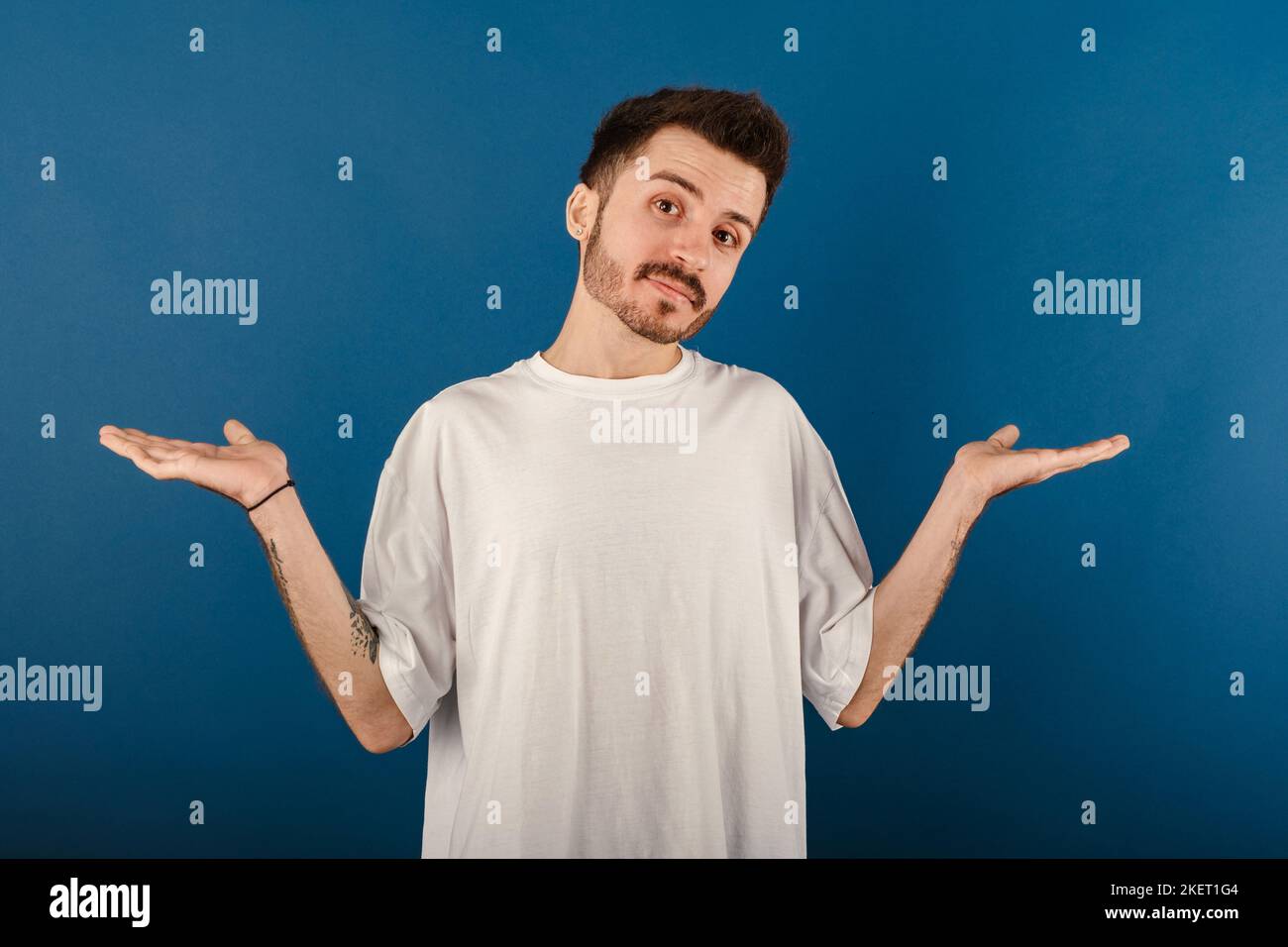 Handsome young man wearing casual clothes posing isolated over blue ...
