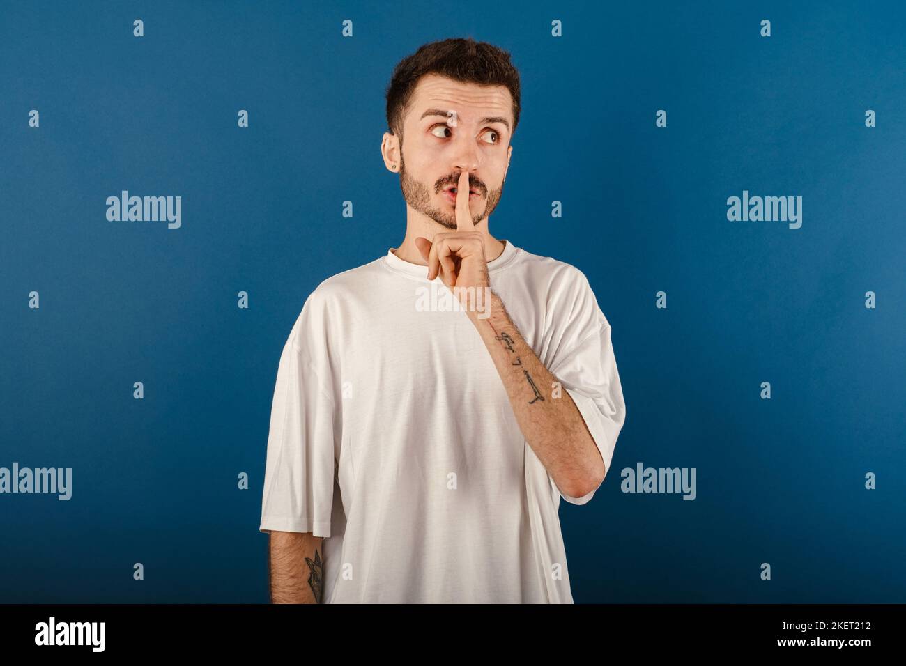 Caucasian young man wearing t-shirt posing isolated over blue ...