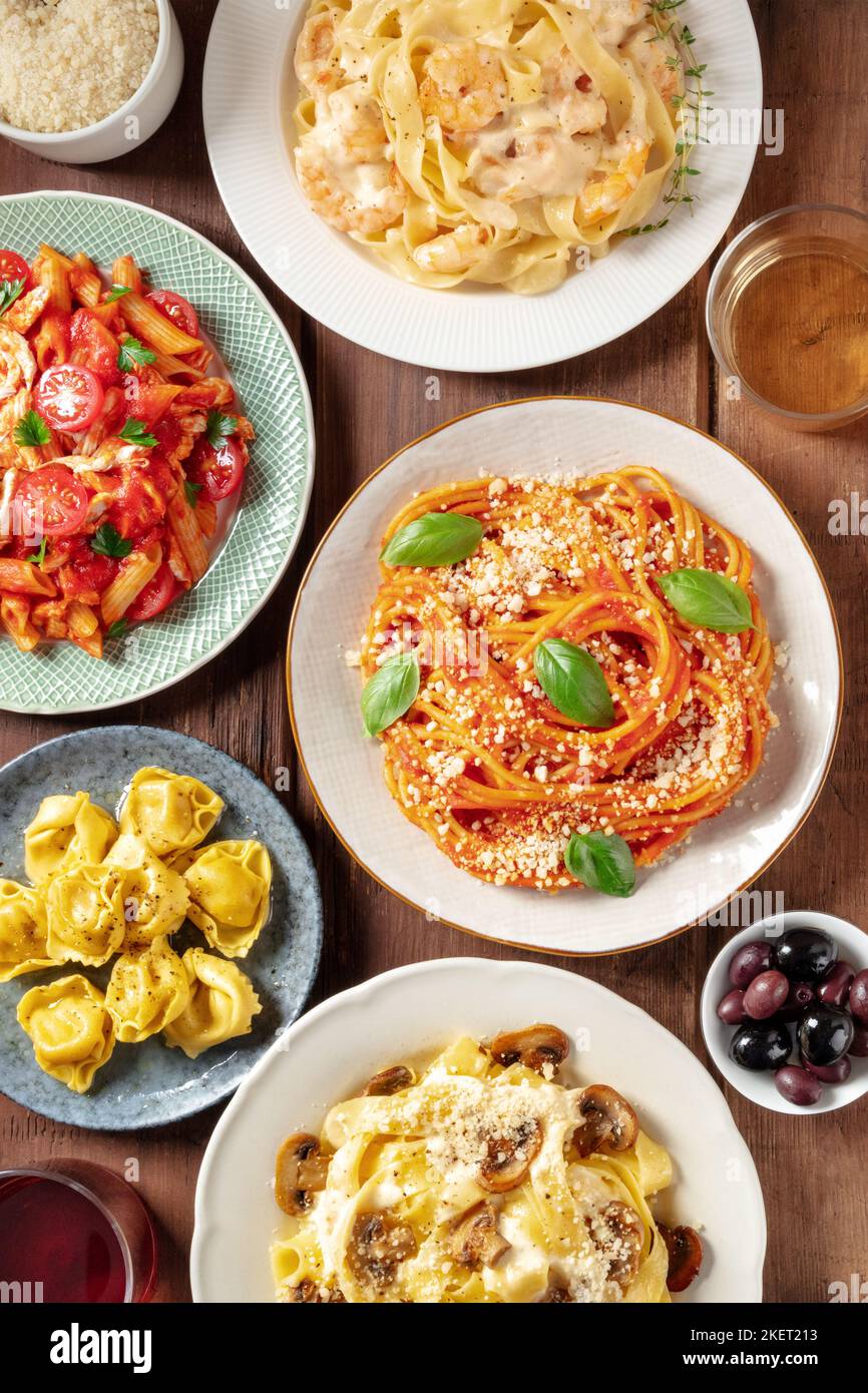 Italian pasta, various dishes, overhead flat lay shot on a rustic ...