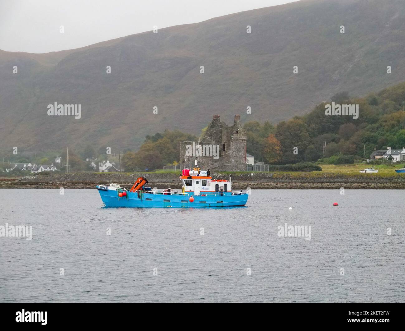 Working boat anchored in front of Lochranza castle, Isle of Arran ...