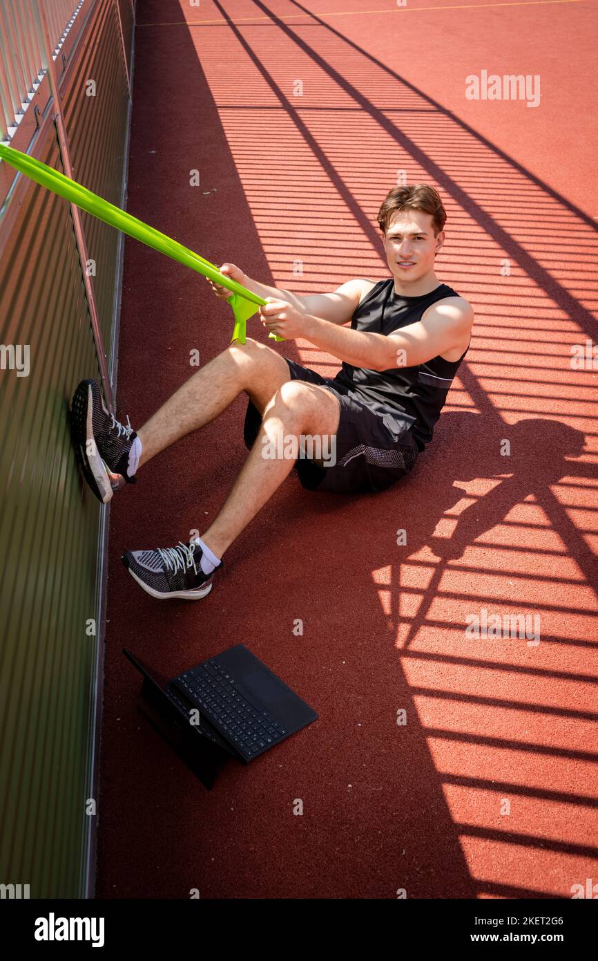 Fitness good looking man doing workout with elastic resistance band ...