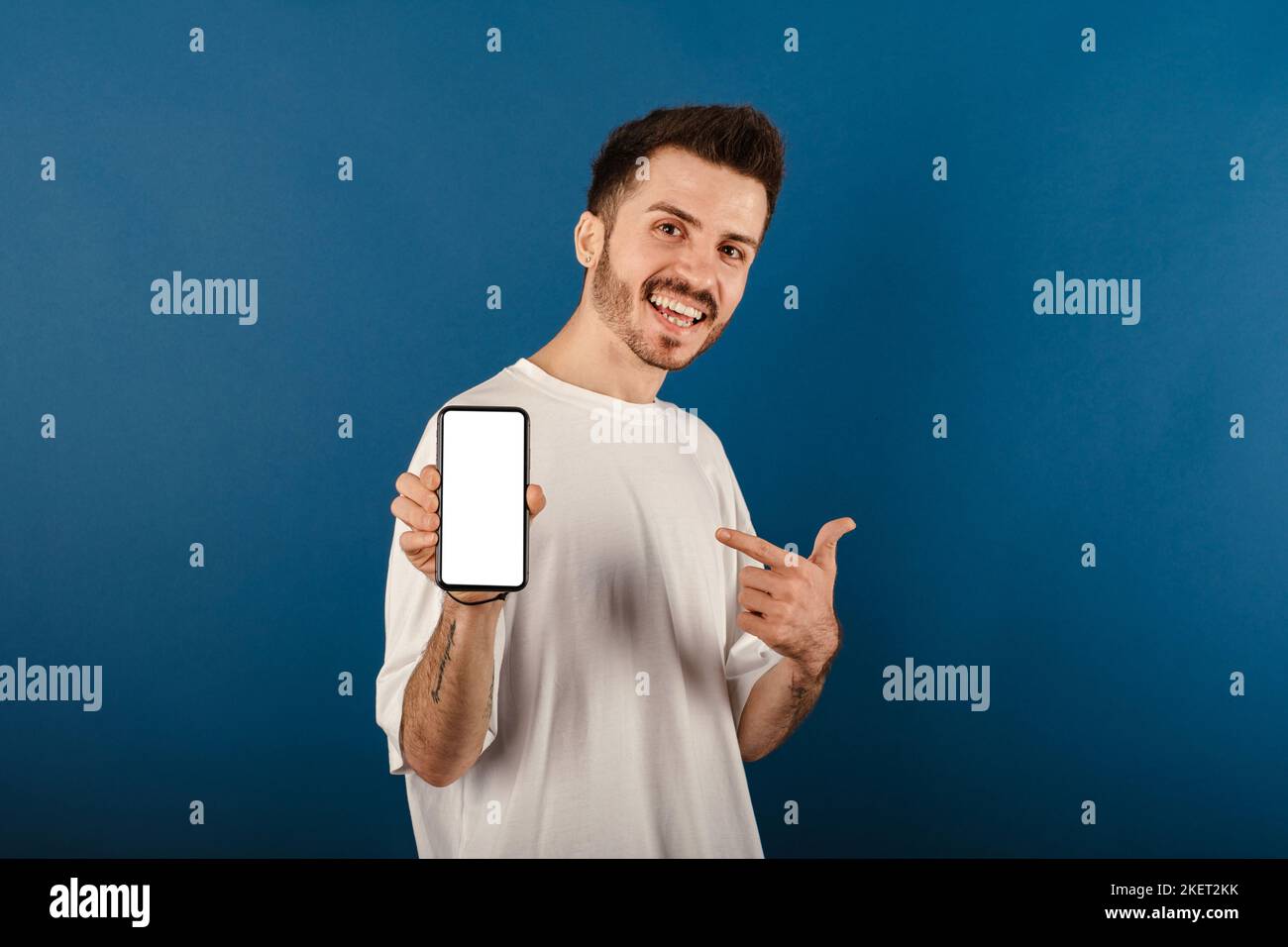 Cheerful caucasian man wearing casual clothes posing isolated over blue ...