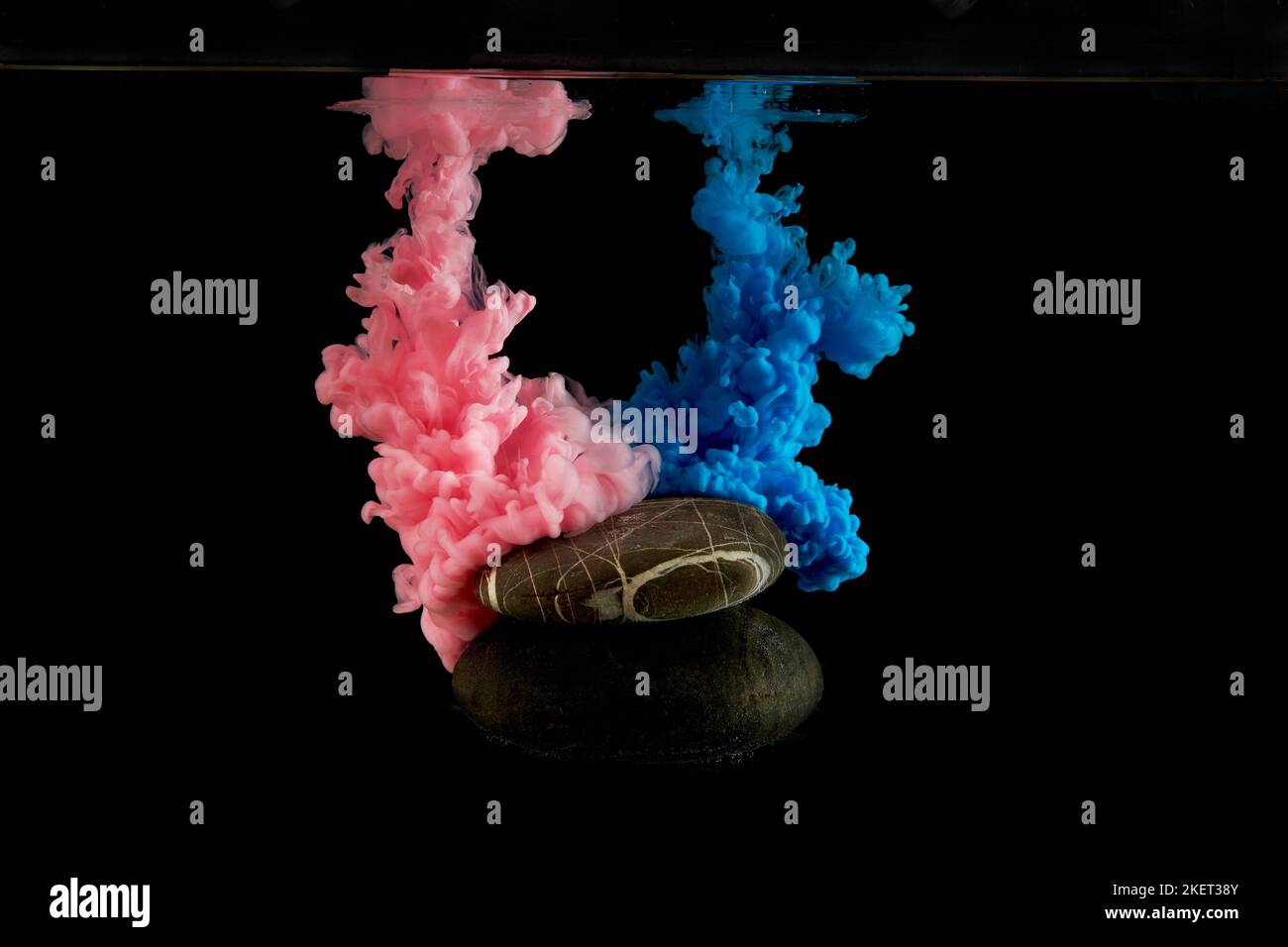 Abstract acrylic paint color swirls in water, black background ...